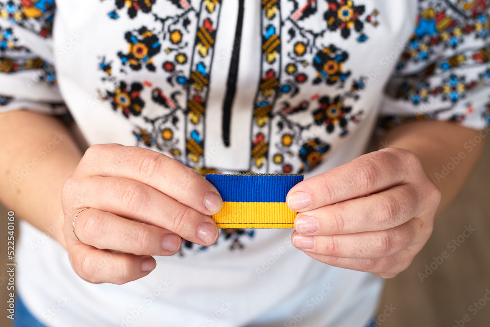 Female in traditional ukrainian clothes hold in hands ribbon with ...