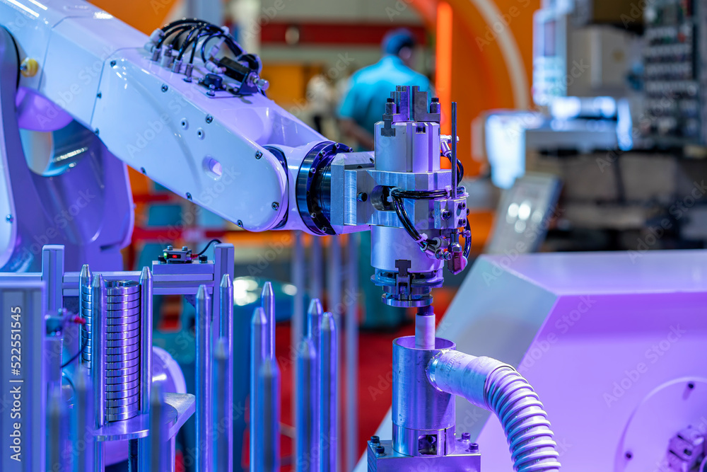 automation system robot arm with gripper during bring process metal ...