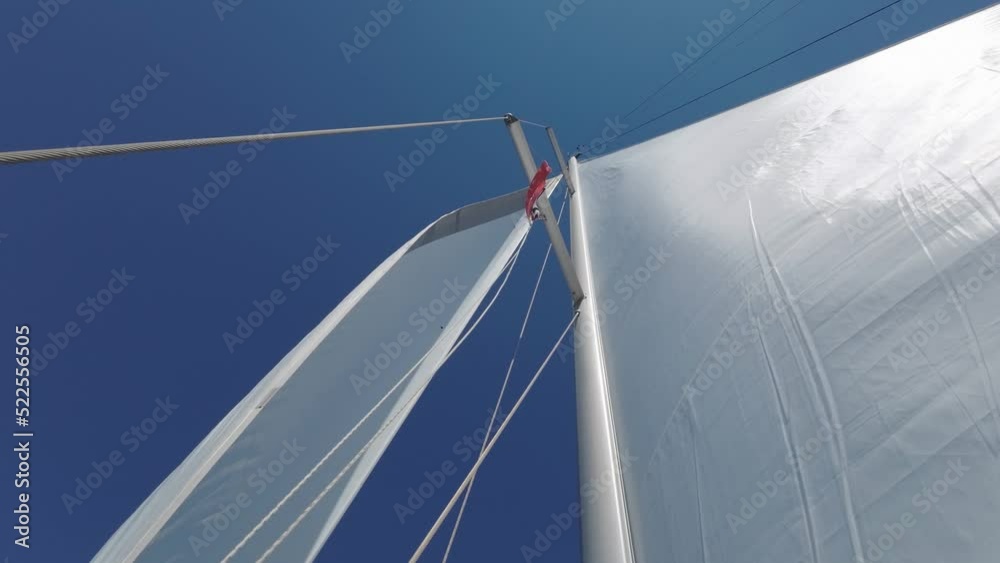 4K Sailboat Mast and Sail. Open, unfurled sails on a yacht. Sailing in ...