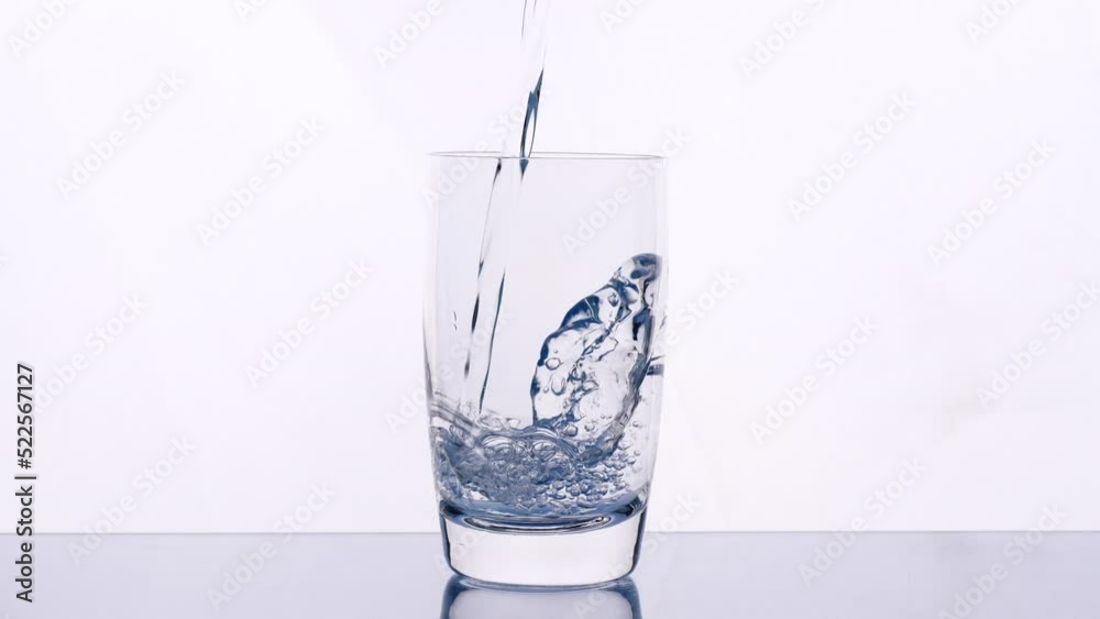 Pouring drinking water. Close up pouring purified fresh clean drinking ...