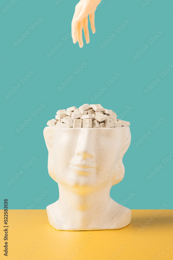 Hand taking keyboard keys from a concrete human head. Digital life ...