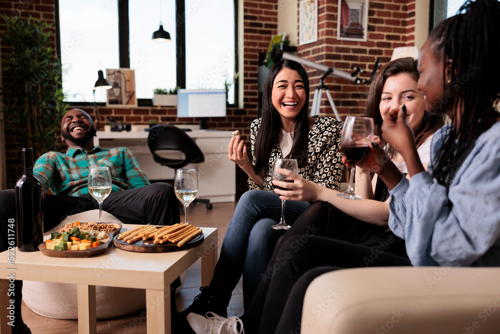 Close friends having wine party and laughing with mouth wide open while ...