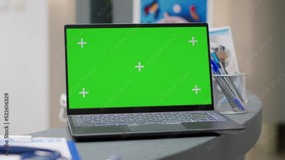 Greenscreen display on laptop at hospital reception desk, private ...