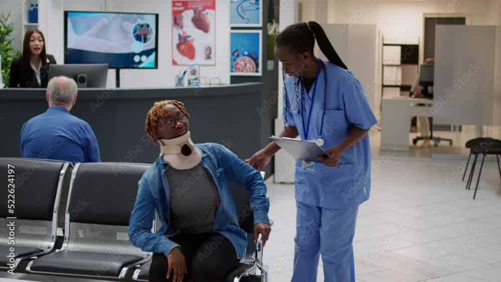 Female patient with neck collar brace attending checkup with doctor and ...