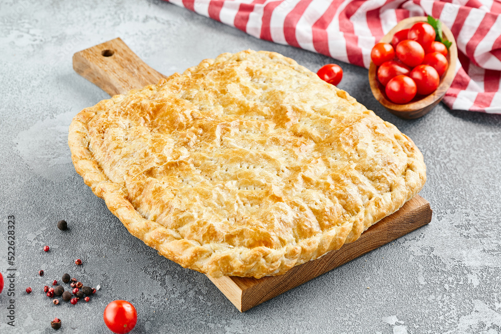Closed pie with puff dough, minced meat and cheese. Meat pie on gray ...
