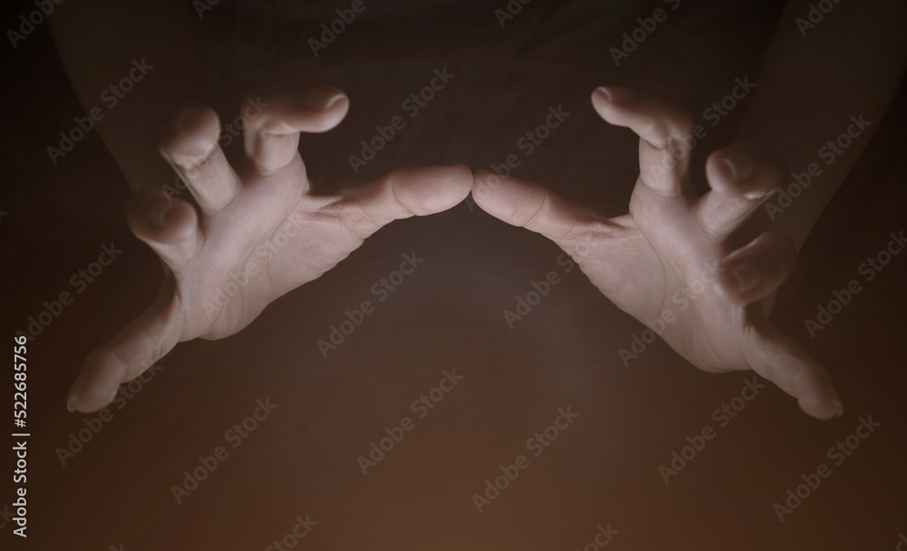 Hand and finger gestures show magic on black background with light and ...