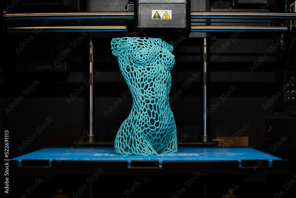 3d printer prints the model of female body, process of creating a bust ...