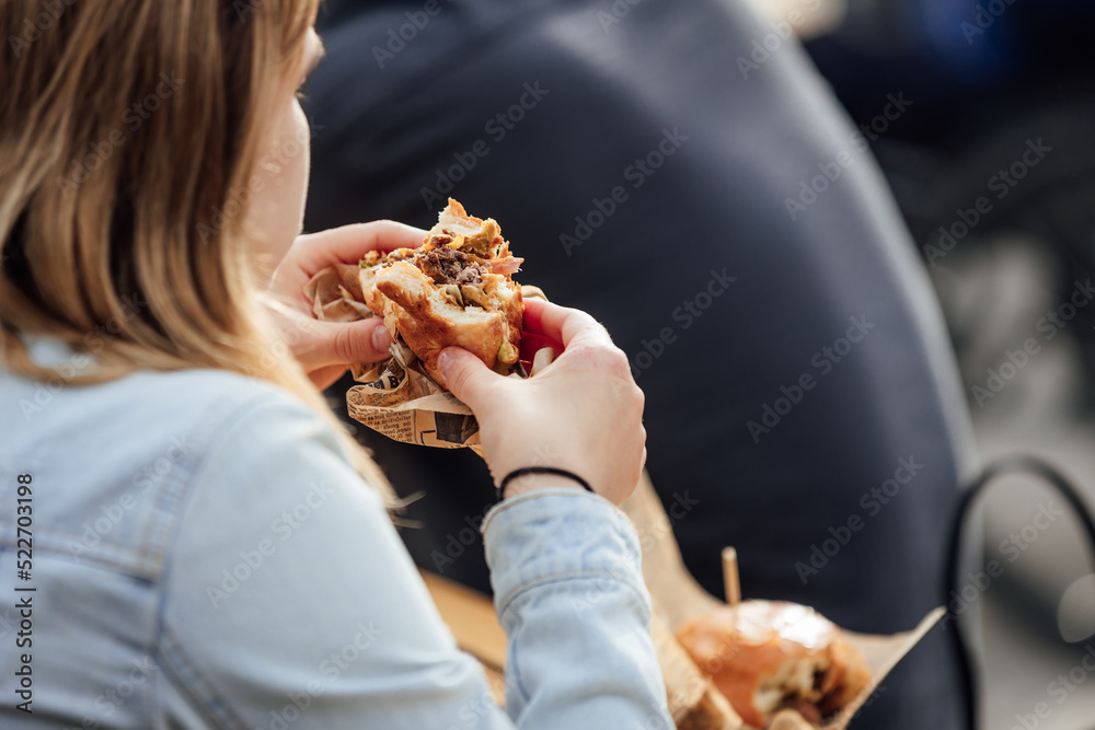 People eating burger at the festival food court, Eating fast food ...