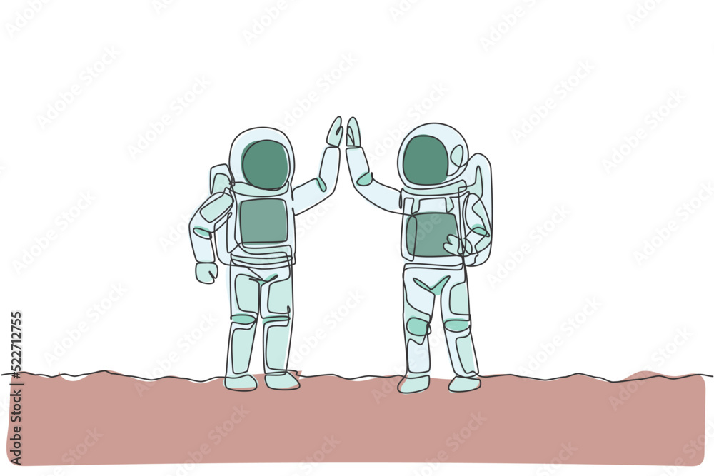 One continuous line drawing of two young happy astronauts giving high five gesture to celebrate ...