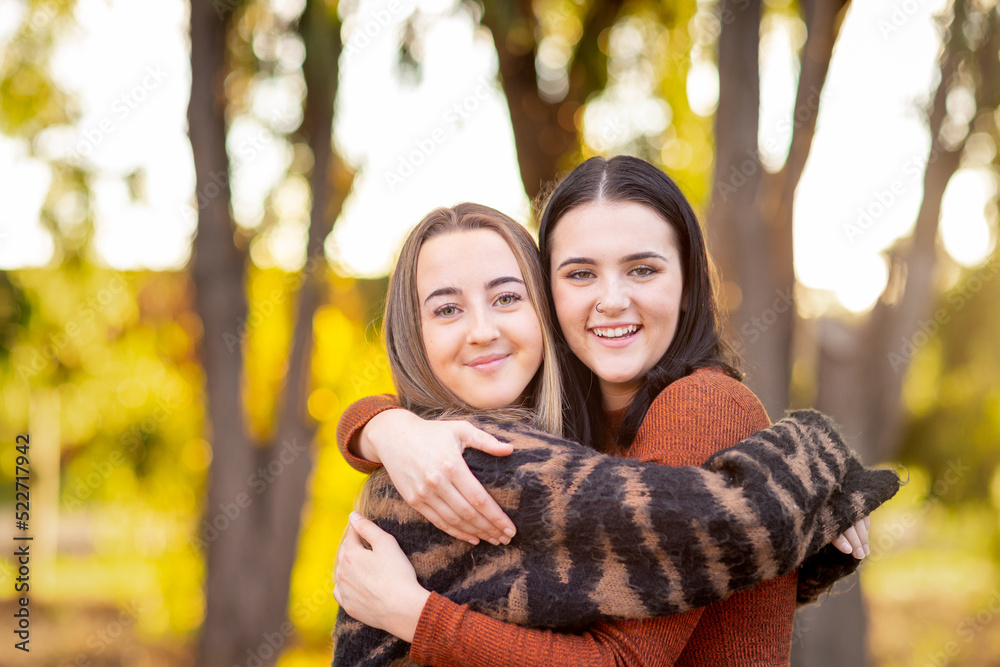 smiling best friends with arms around each other Stock Photo | Adobe Stock