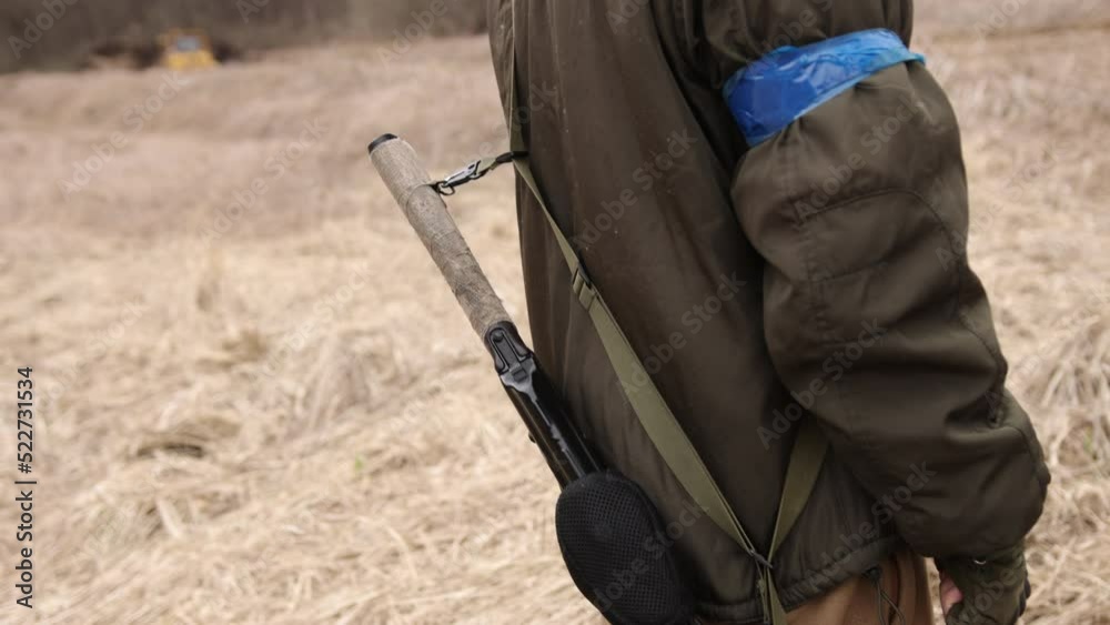 Man holds machine gun behind back. Secret agent with rifle. Male ...