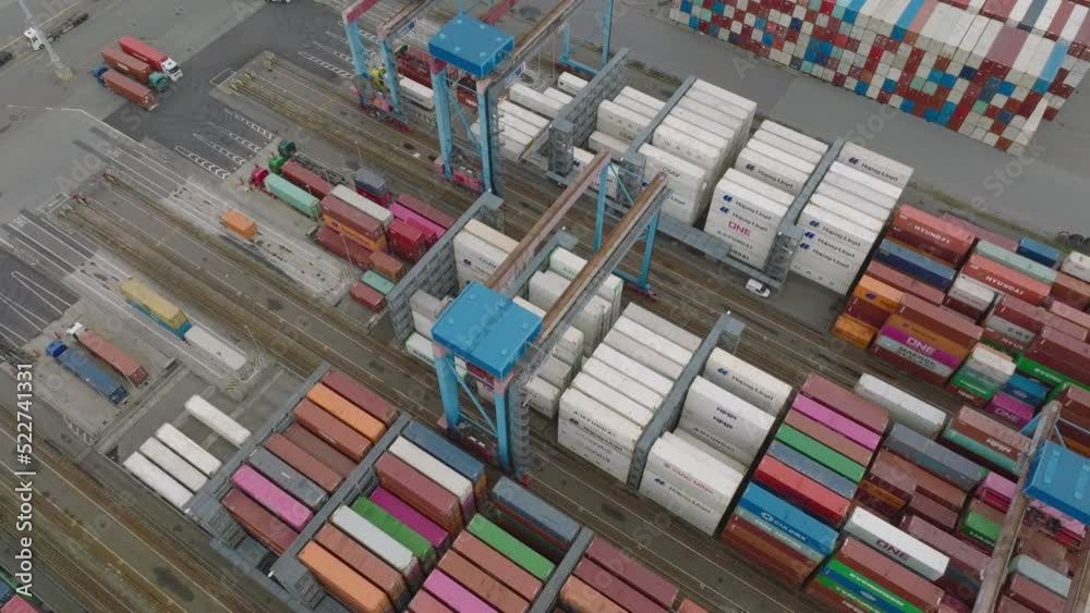 Large portal container crane passing over smaller one. Work on cargo ...