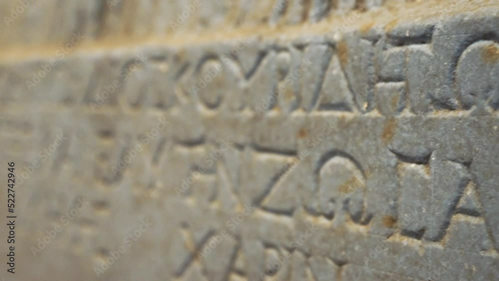 Ancient Greek manuscript engraved in a stone wall. Inscription written ...