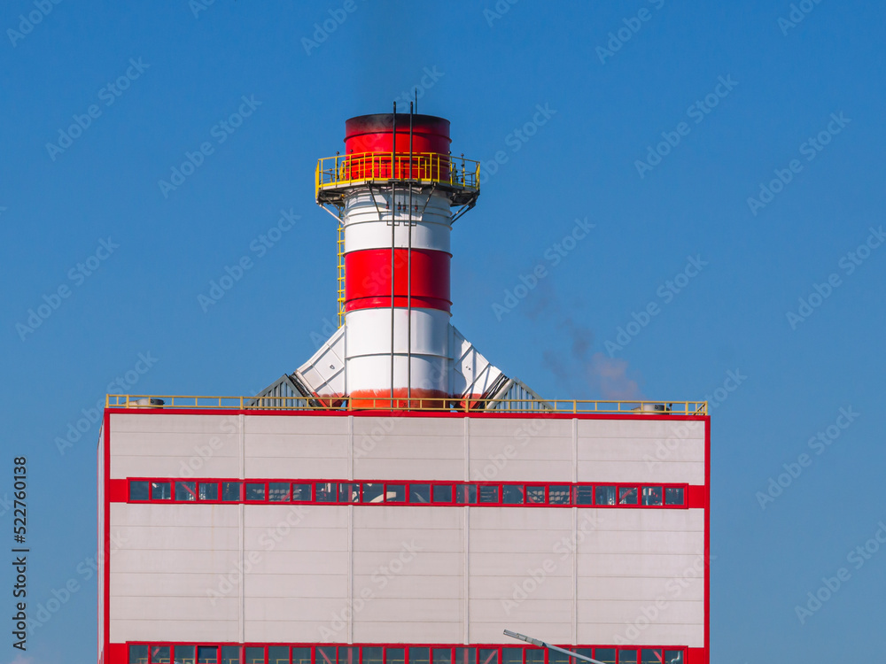 Red and white pipe of a thermal power plant. Conversion of chemical ...