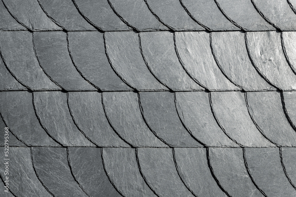 Detail close-up of natural grey stone shingle slate tiles texture roof ...
