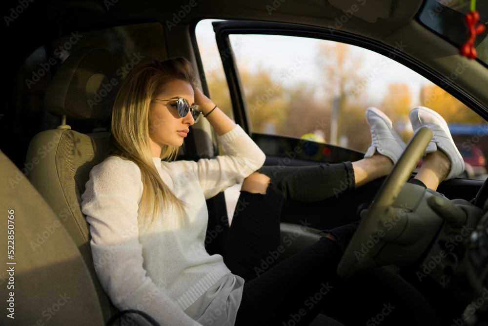 Beauty portrait of pretty girl in car on parking in evening. Stylish ...