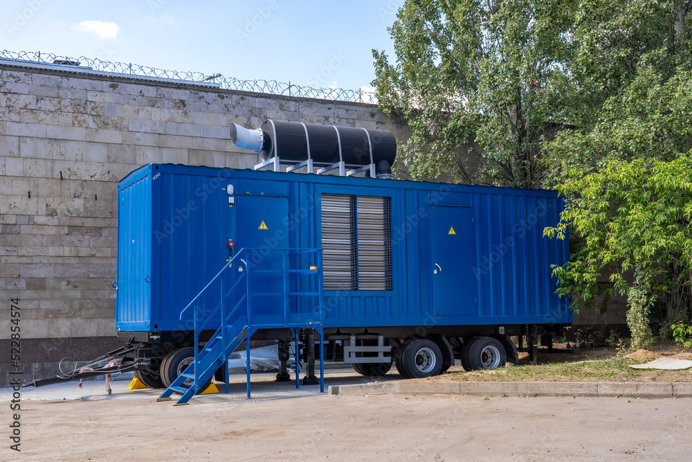 Modern blue diesel powered emergency backup electric generator on ...