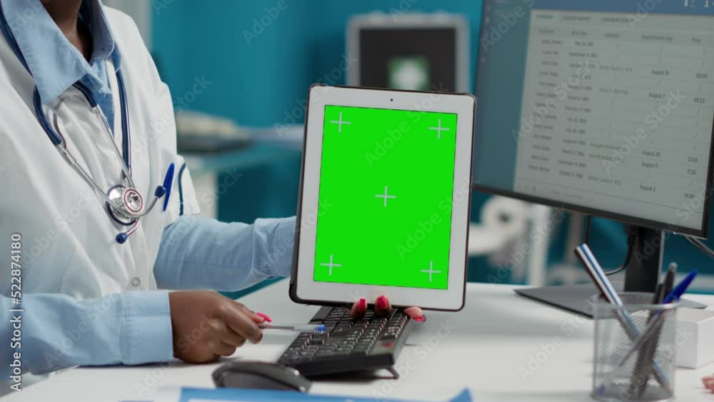 Female doctor holding tablet with greenscreen at checkup with paralyzed ...