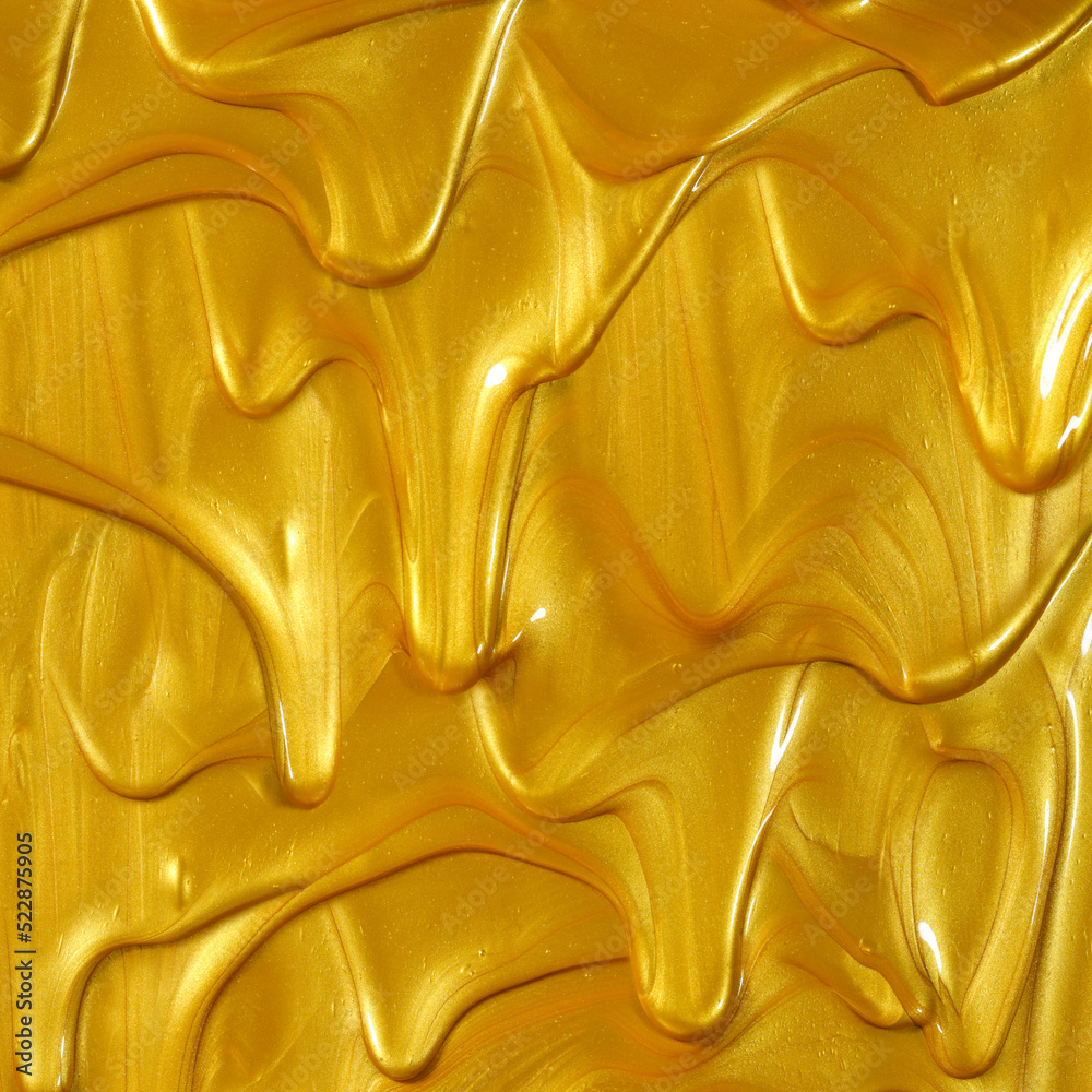 Glittering shiny metallic gold paint flowing and dripping downward ...