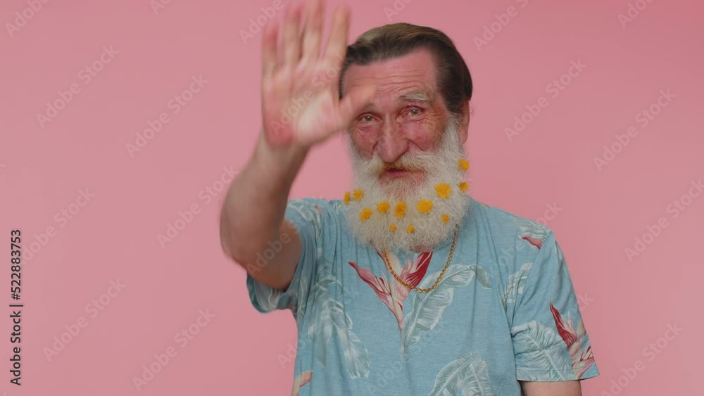 Handsome senior beard old man smiling friendly at camera and waving ...