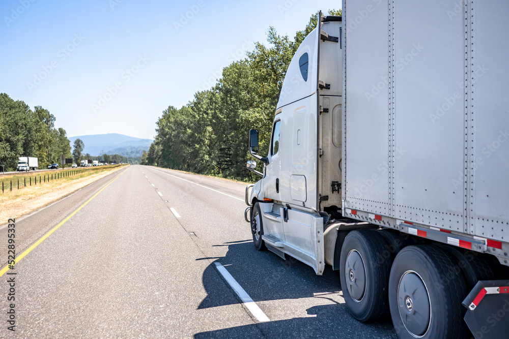 Industrial long hauler big rig semi truck transporting cargo in dry van ...