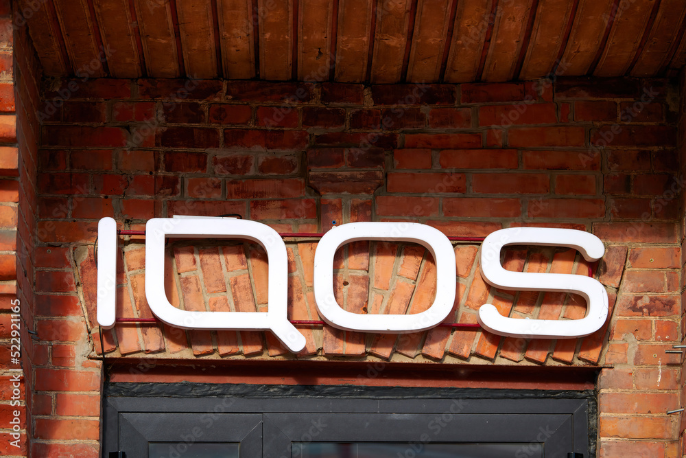 Pinsk, Belarus. Jun 2022. Sign IQOS. Company modern neon signboard IQOS ...