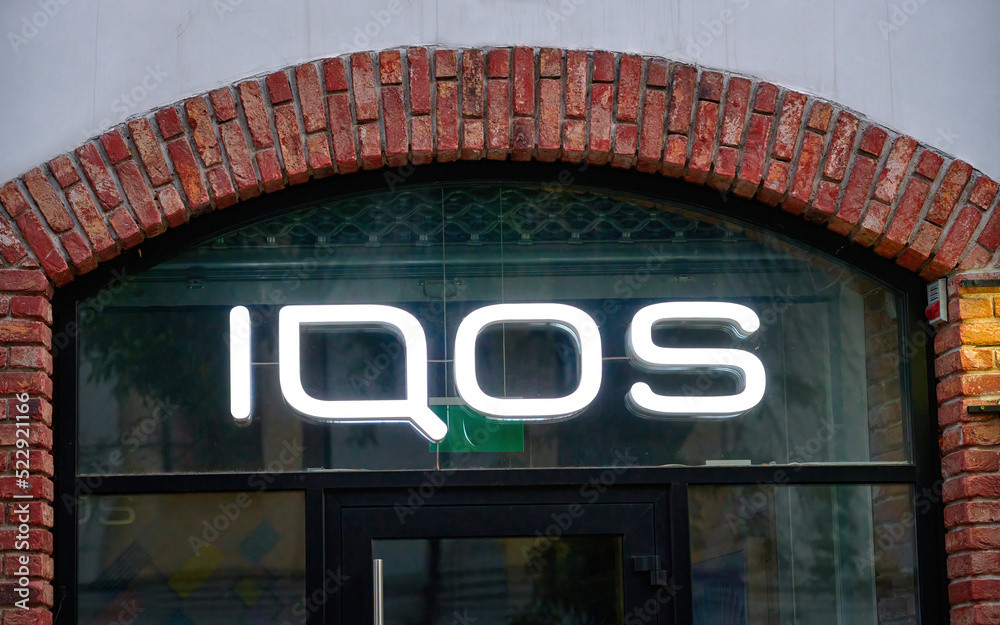 Brest, Belarus. Jun 2022. Sign IQOS glowing in evening. Neon company ...