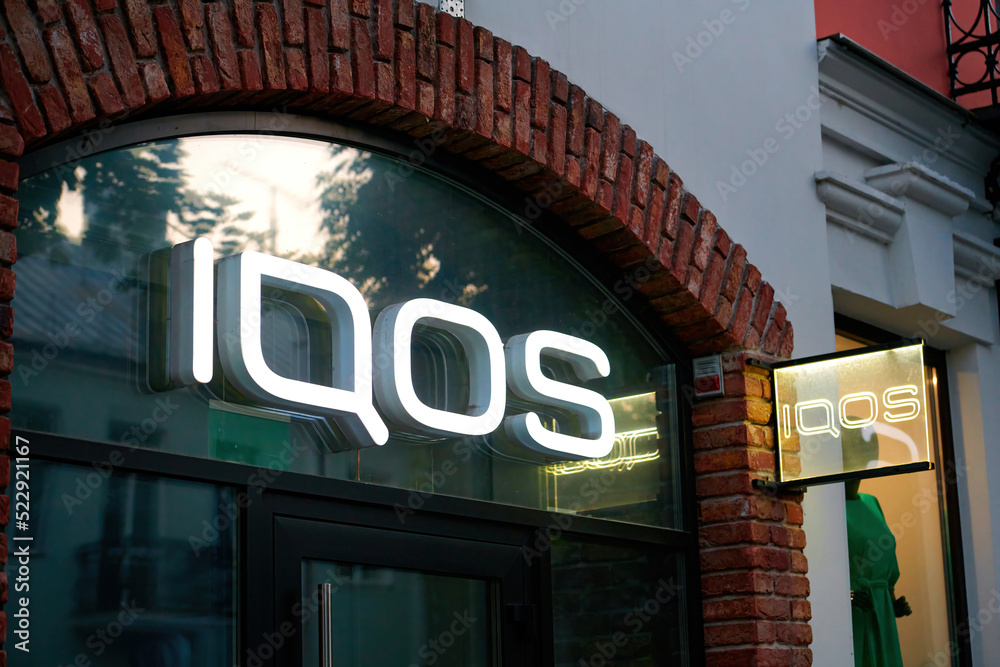 Brest, Belarus. Jun 2022. Sign IQOS glowing in evening. Neon company ...