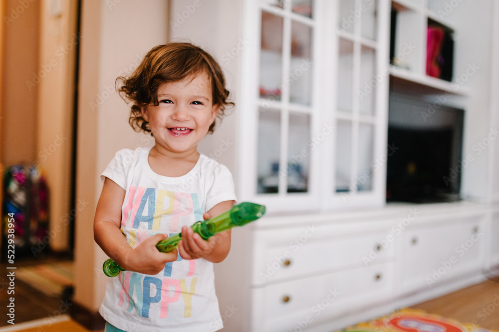Portrait of a toddler, girl, adorable baby playing reed pipe, panpipe ...