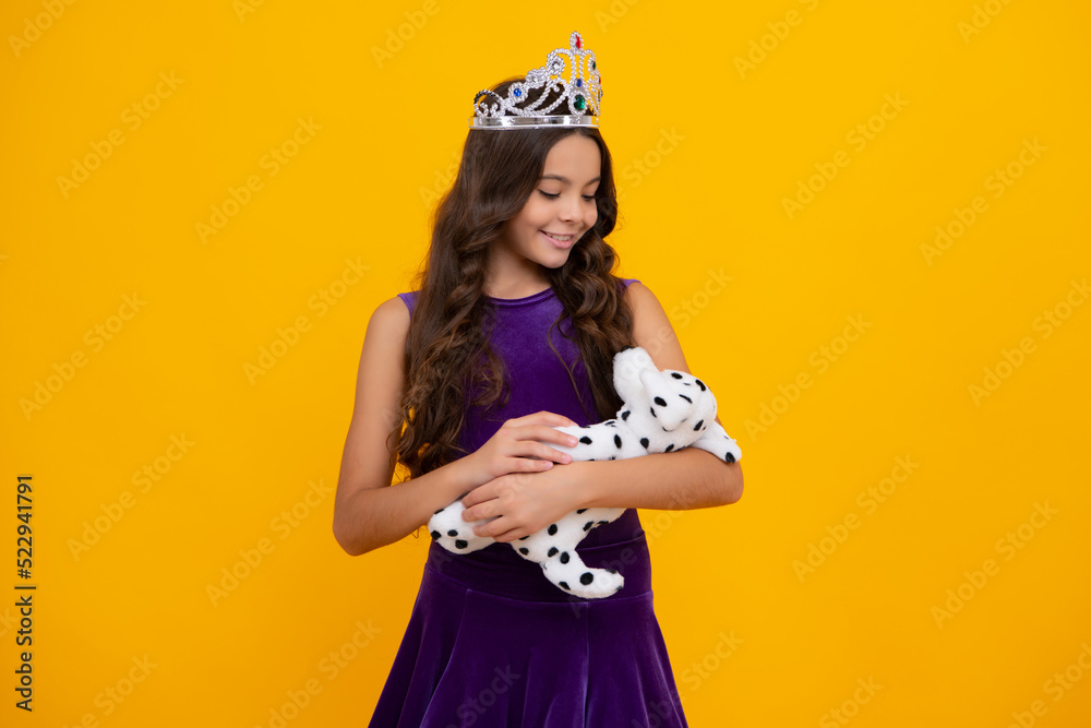 Little queen wearing golden crown. Teenage girl princess holding crown ...