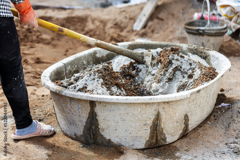 construction workers spreading freshly poured concrete cement mix on ...