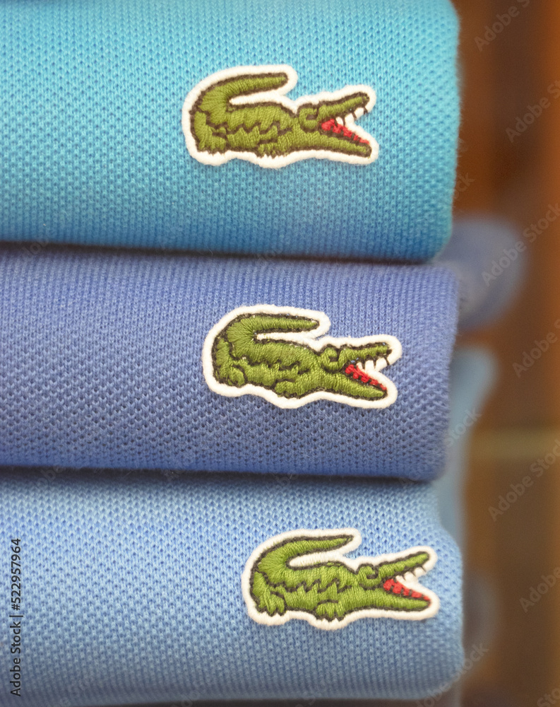 Focus on the crocodile logo of Lacoste shirts in different shades of ...
