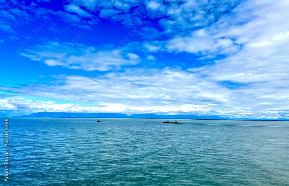 unrealistically white-gray silver Clouds on a bright blue sky a little ...