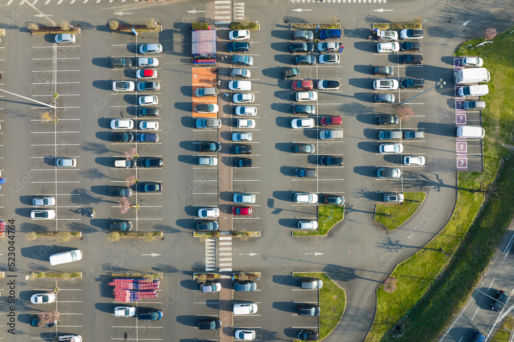 Aerial view of many colorful cars parked on parking lot with lines and ...