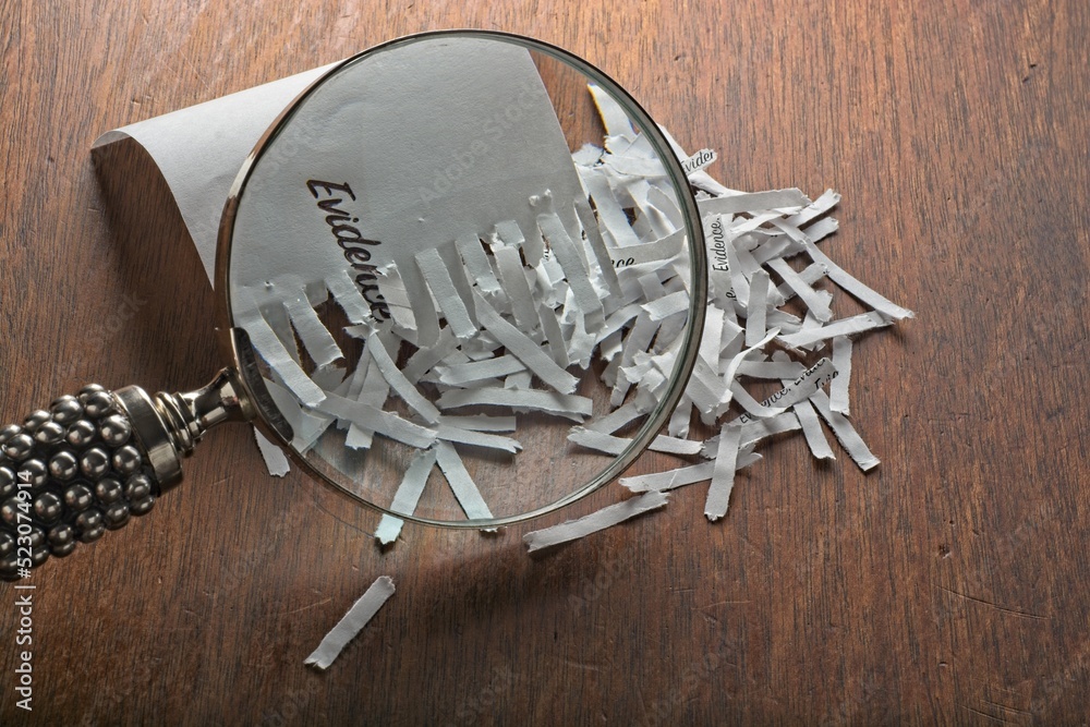 Shred of Evidence concept divulging the word ‘Evidence’ recovered from ...