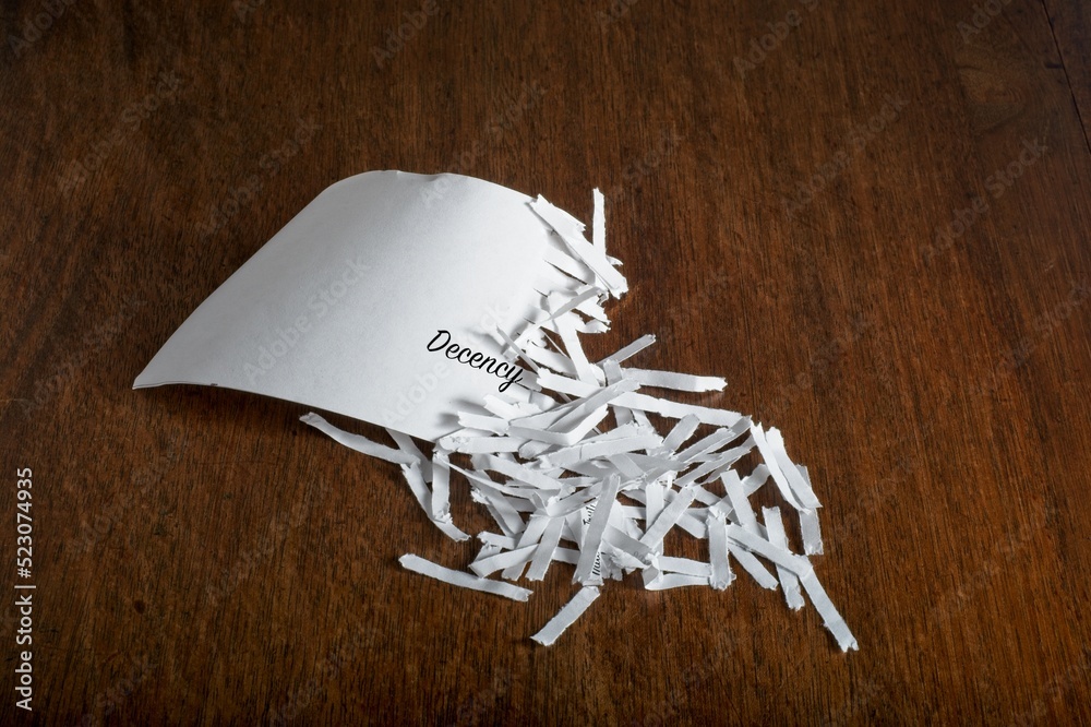 Shred of Decency concept shows the word ‘Decency’ recovered from a pile ...