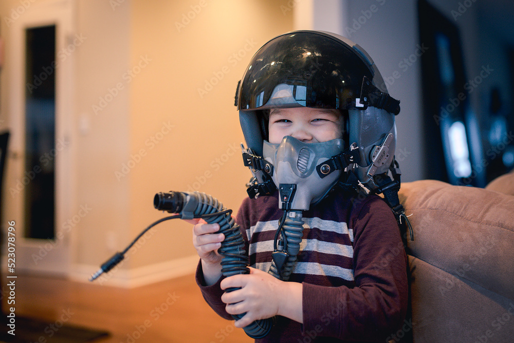 A smiling boy wearing an Air Force military fighter pilot helmet Stock ...