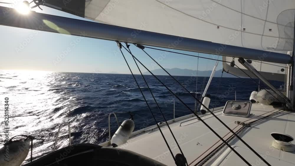 View from a floating sailing yacht with spread sails splitting the sea ...