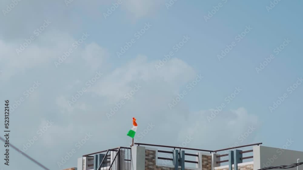 India flag. Indian flag displaying on a pole on top of the house. Slow ...