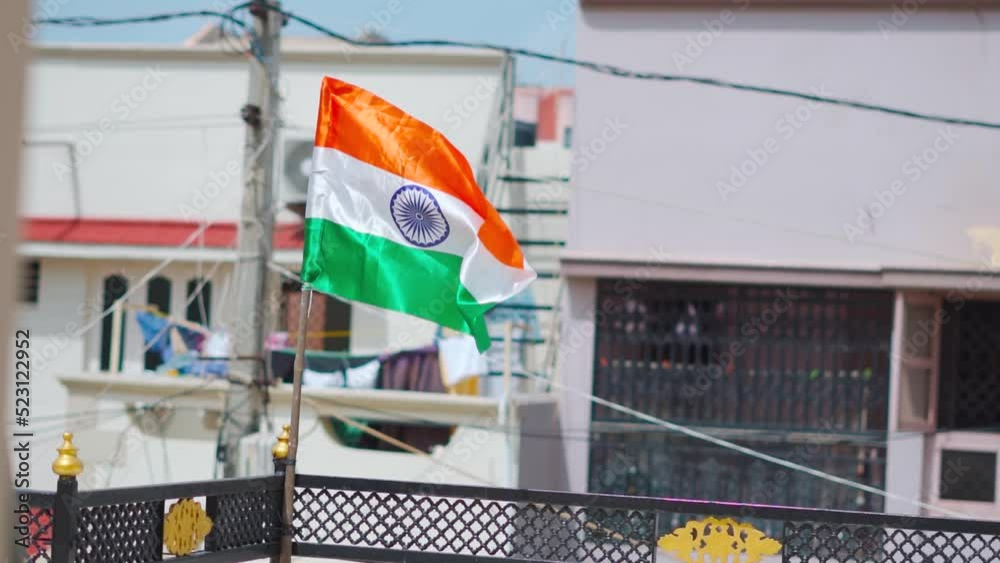 India flag. Indian flag displaying on a pole in front of the house. Tricolor flag waving in ...