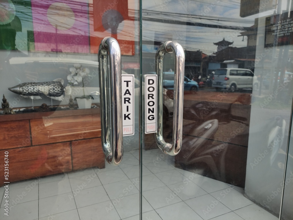 Push and pull door sign. In Indonesian, "Dorong" means push, "Tarik ...