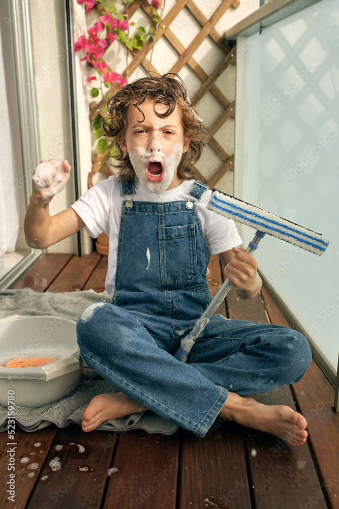 Full length of excited boy with foam in shape of beard screaming and ...