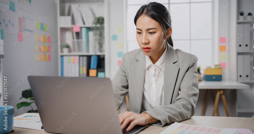 Young Asia businesswoman sitting on desk crazy with overworked stress ...