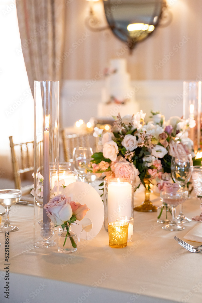 Flowers and candles on wedding reception table Stock Photo | Adobe Stock