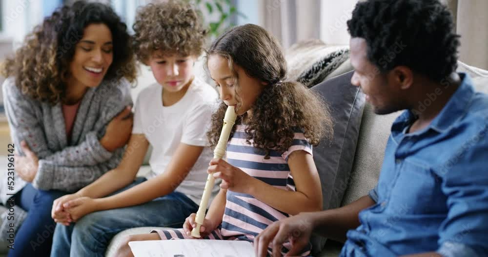 Little girl playing a recorder, family clapping and bonding in the ...