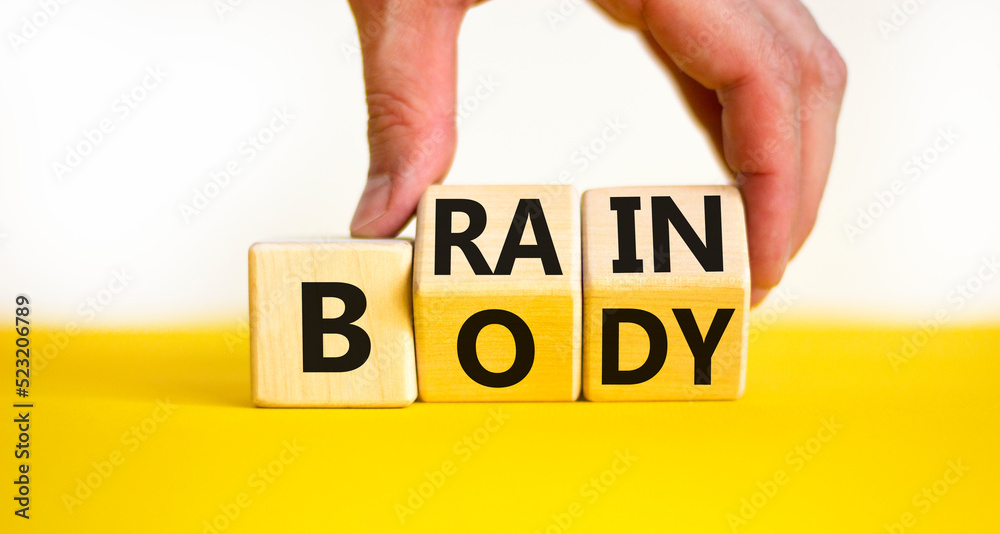 Body vs brain symbol. Businessman turns wooden cubes and changes ...