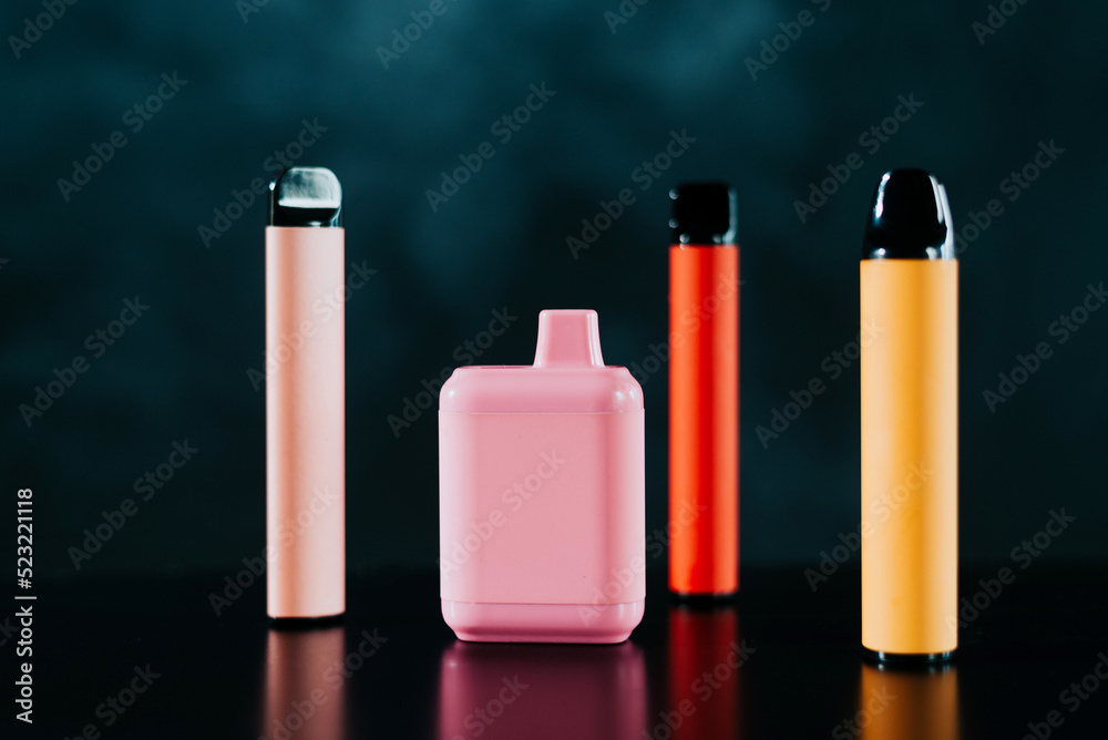 A set of colorful disposable electronic cigarettes of different shapes ...