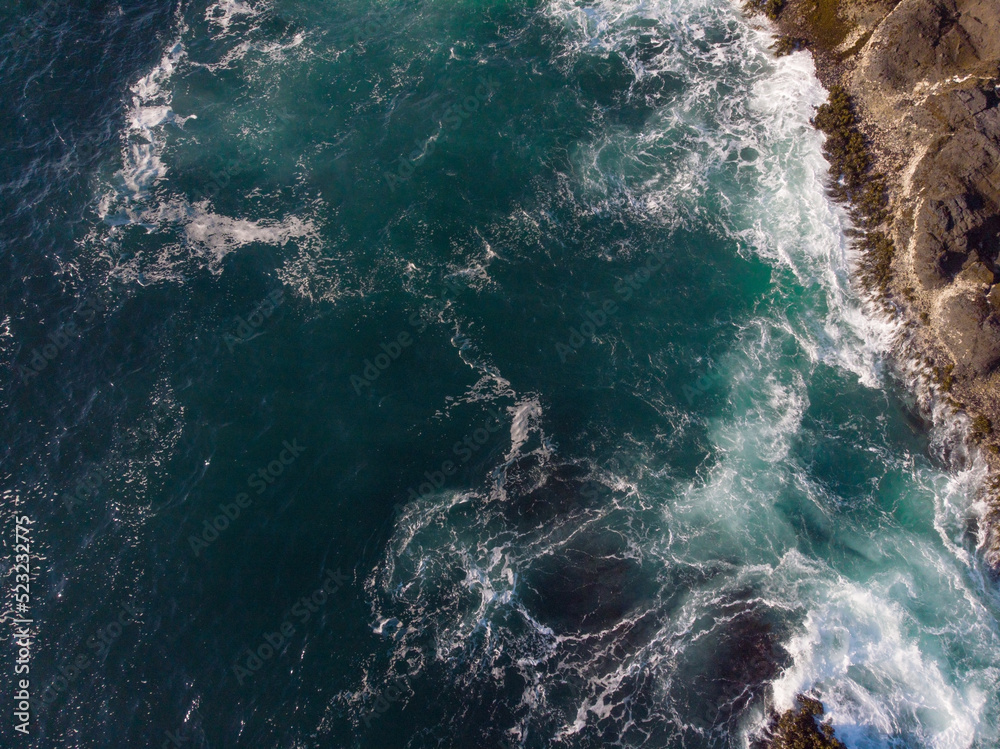 Top view of the ocean. Turquoise water surface of the ocean and white ...
