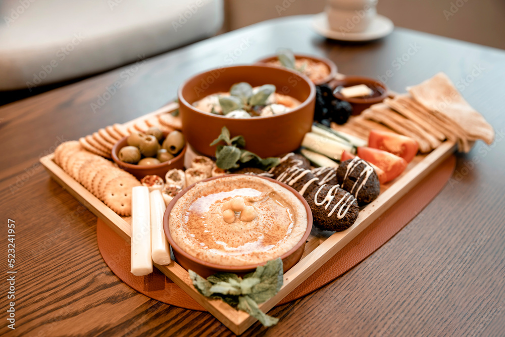 Traditional arabic breakfast on a table: eggs with tomatoes, green ...