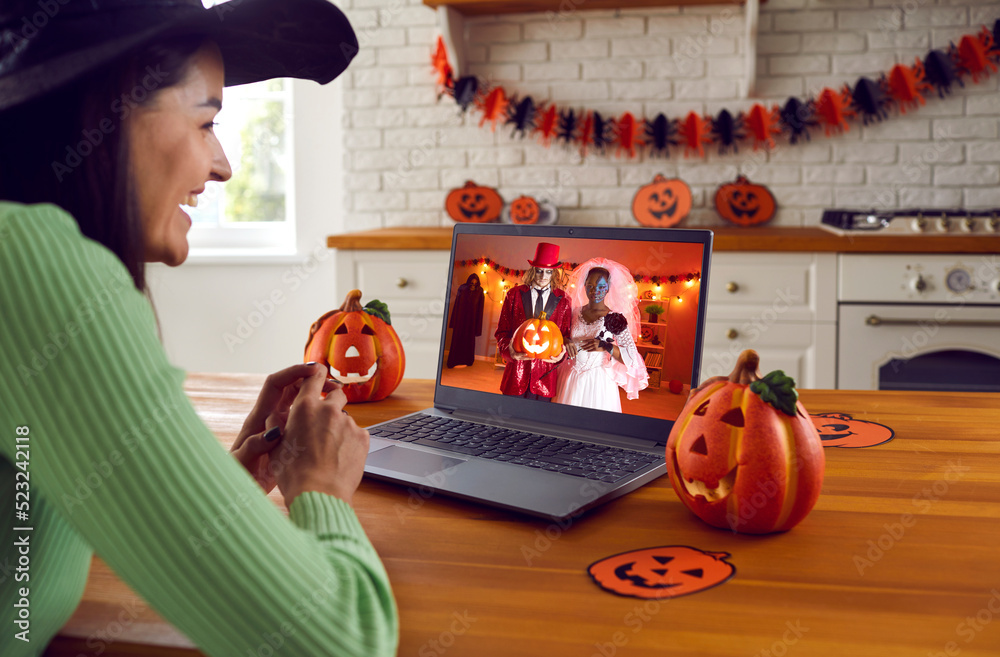 Woman happy to see her friends at virtual Halloween costume party ...